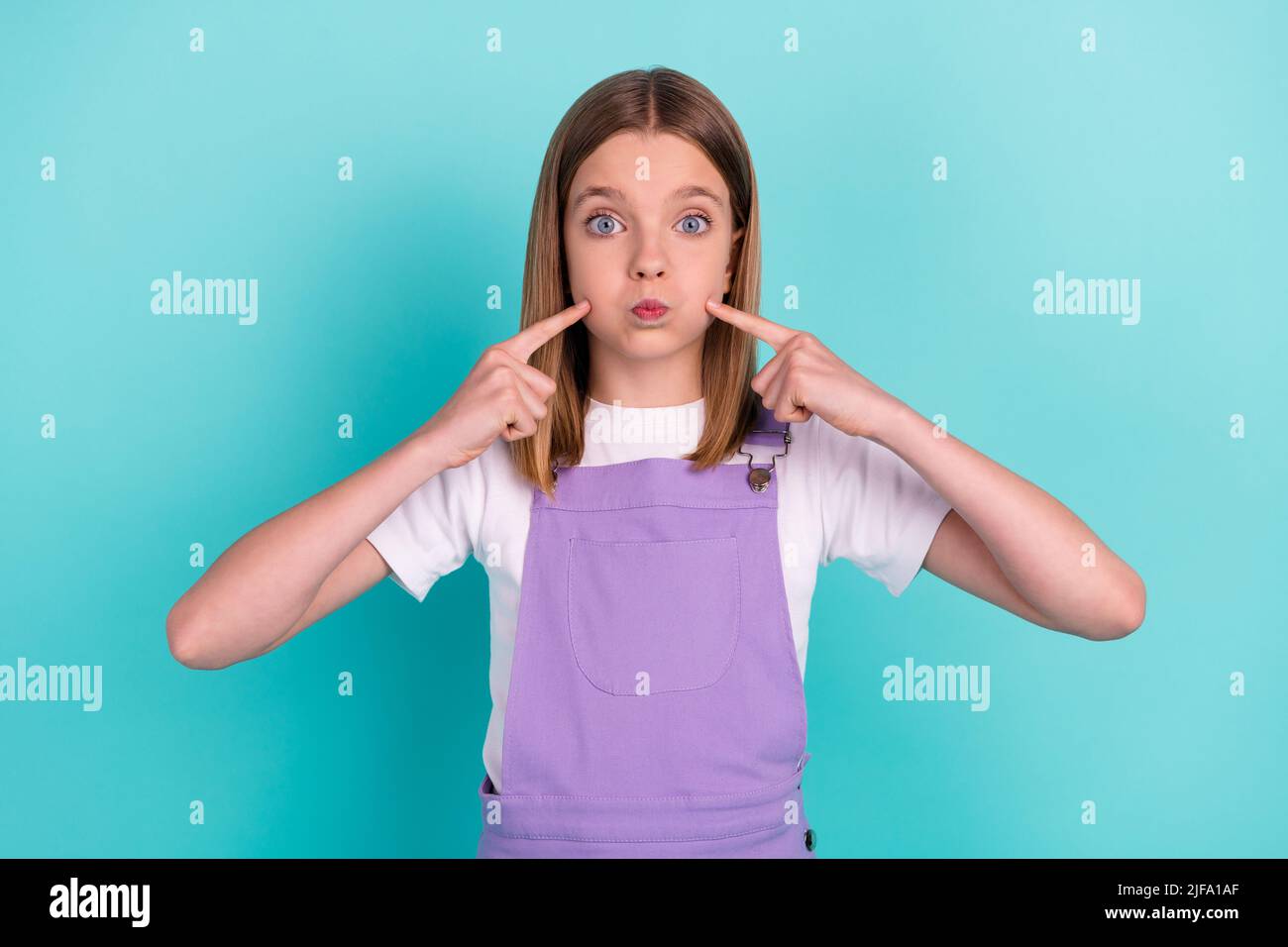 Portrait of carefree excited girl pupil finger press pouted cheeks hold ...