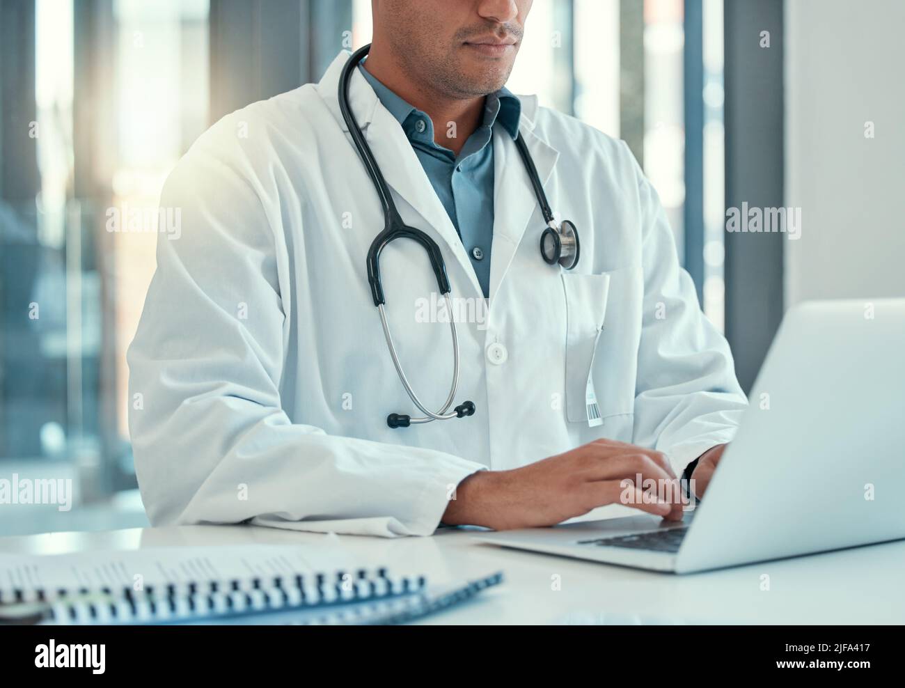 Hands of doctor working on a laptop cropped. medical professional ...