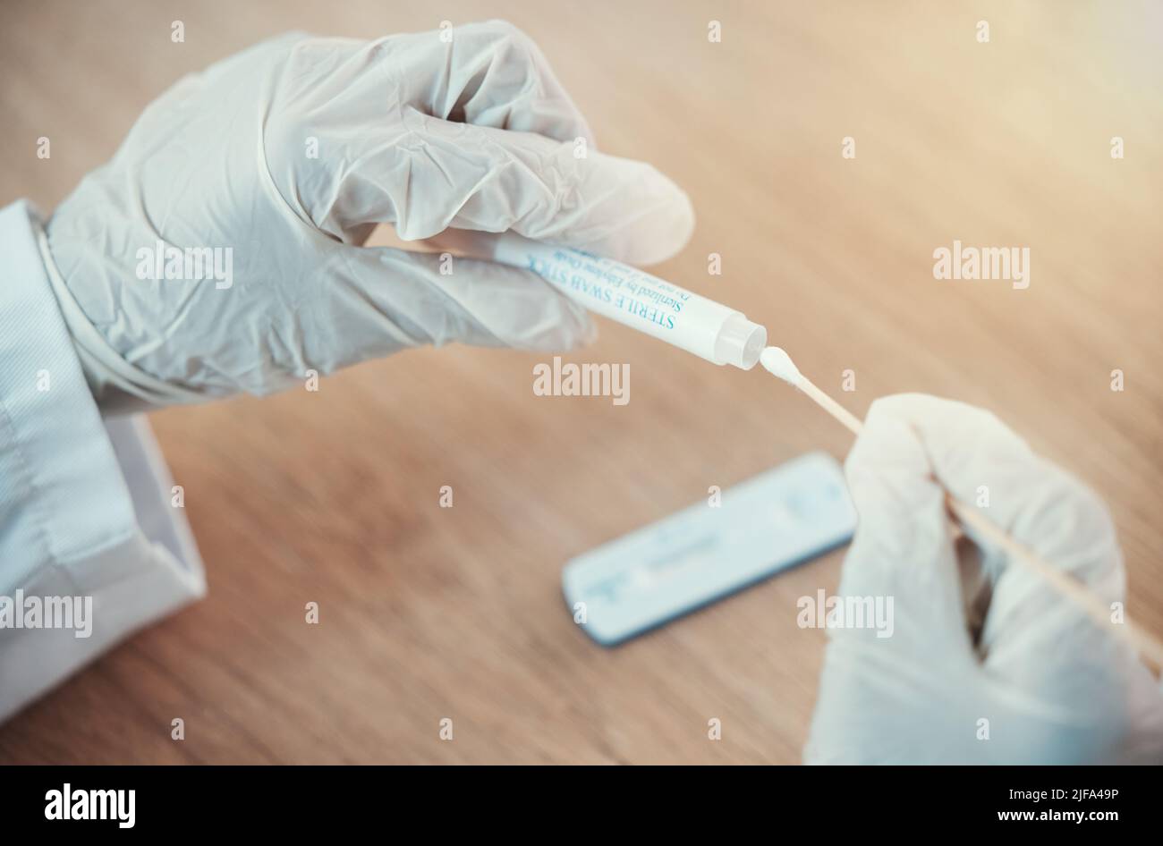 Hands of doctor holding corona virus test swab and sample. Closeup on ...