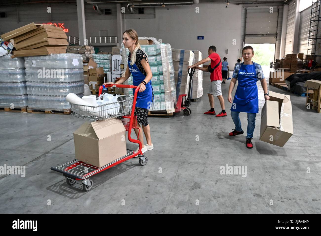 ZAPORIZHZHIA, UKRAINE - JUNE 30, 2022 - Workers are seen at a warehouse ...