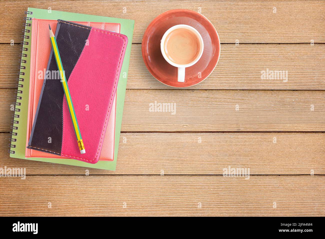 Notebooks and cup of coffee on office desk or wood table. top view with ...