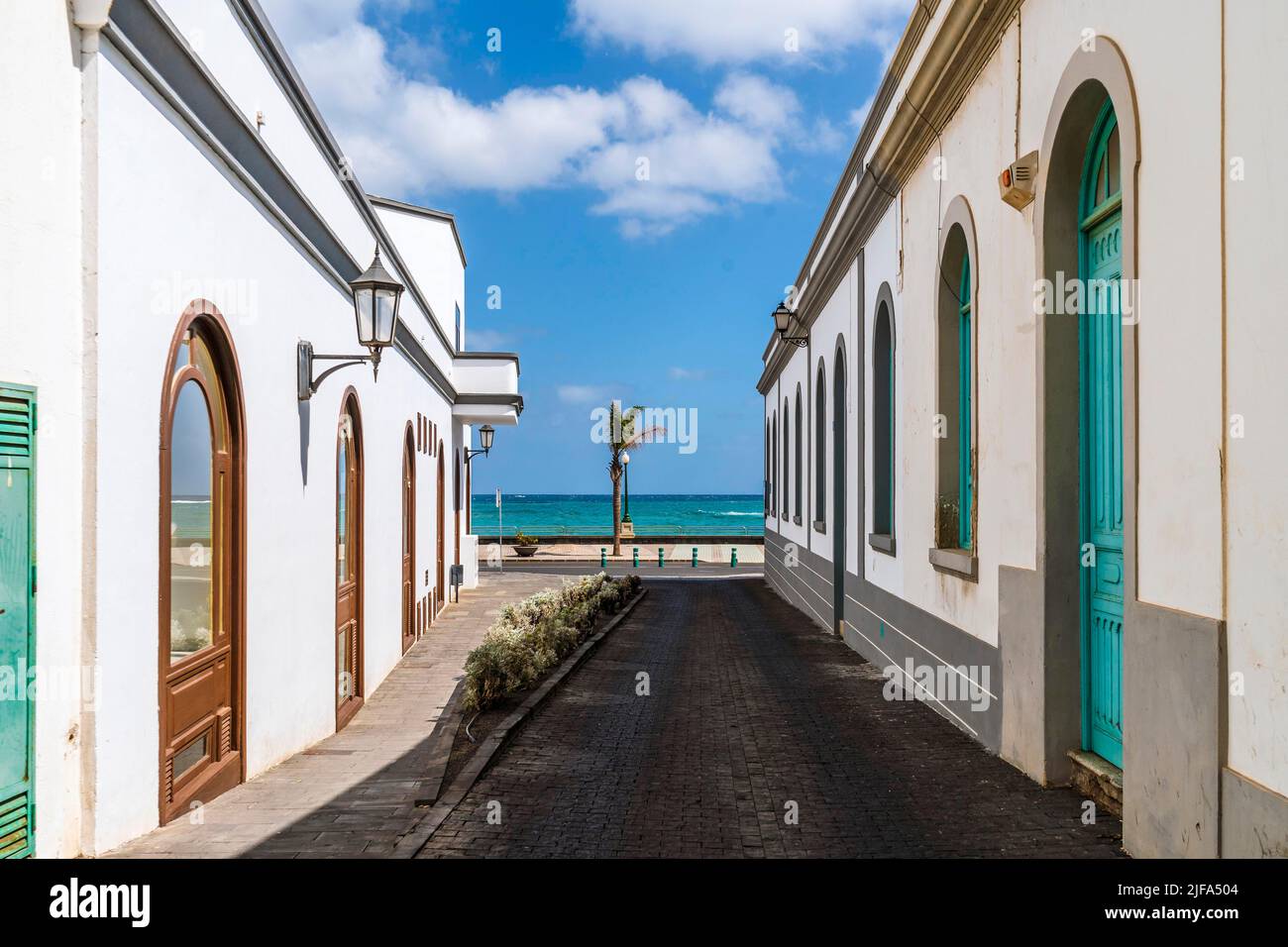 Charming traditional street with whitewashed houses and colorful ...