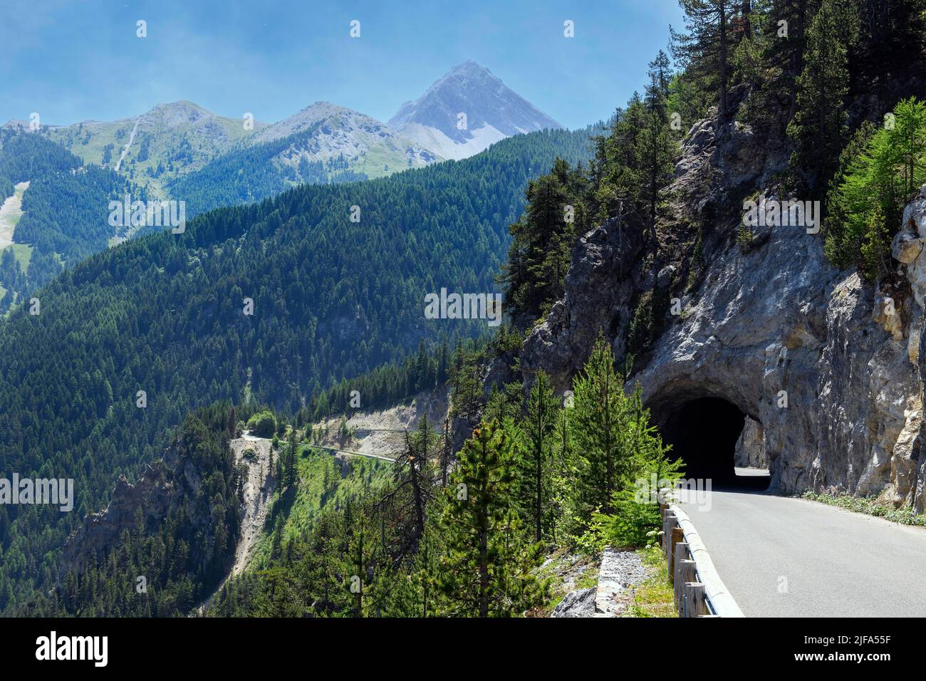 Mountain road with tunnel on steep rock face with tree cover, Nevache ...