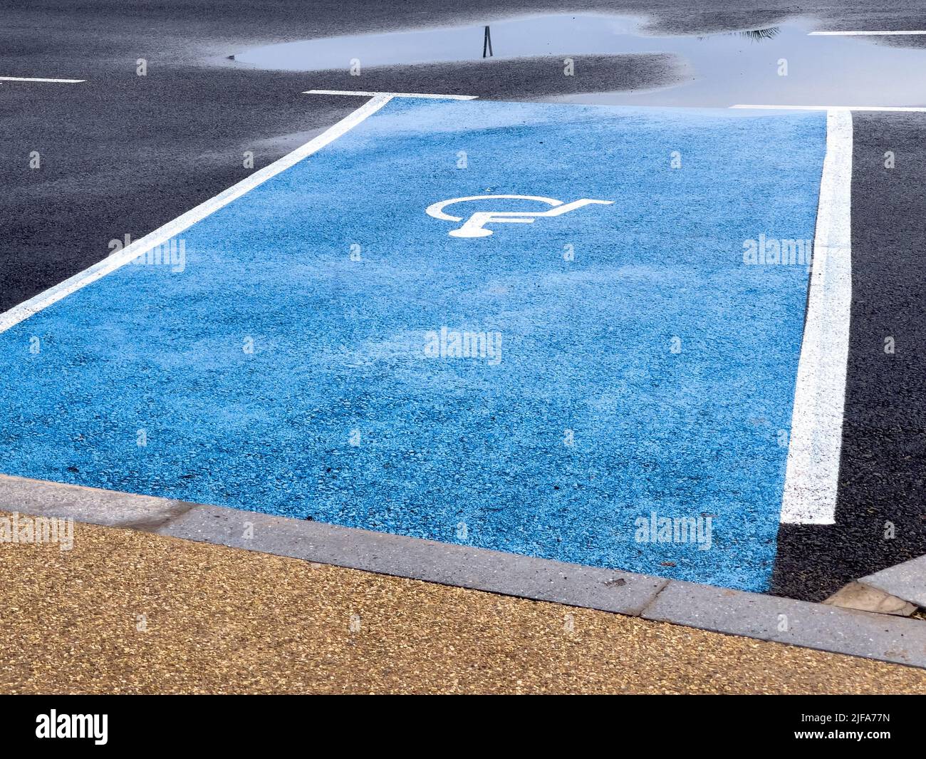 Disabled parking space in an empty outdoor parking lot Stock Photo - Alamy