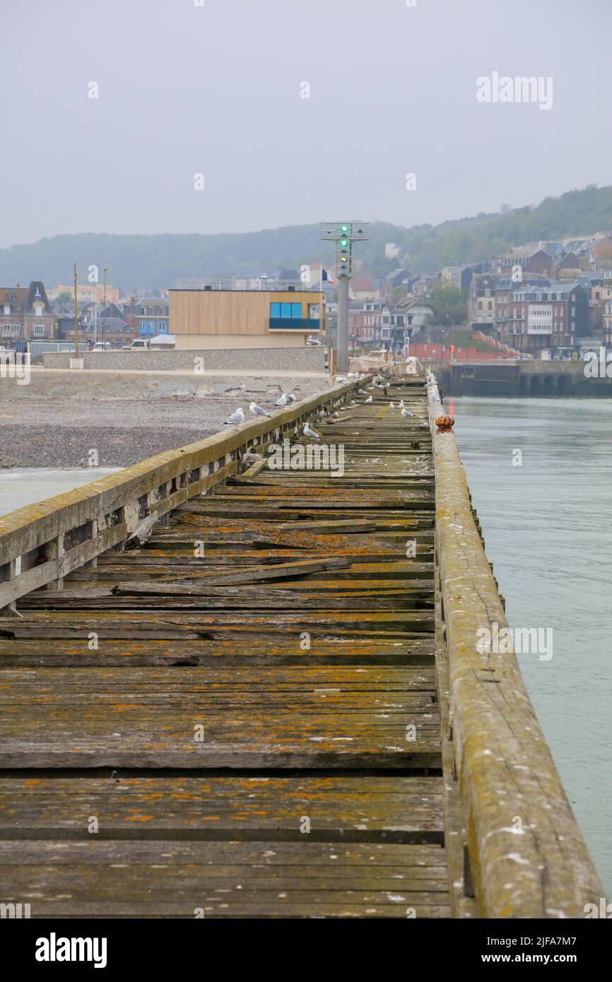 Old wooden jetty in the harbour of the coastal village of Le Treport at ...