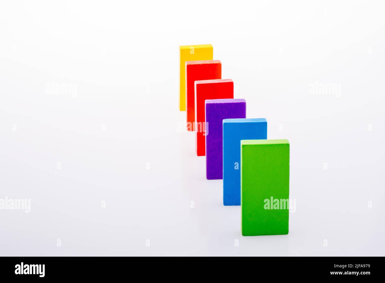 Colorful Domino Blocks in a line on a white background Stock Photo - Alamy