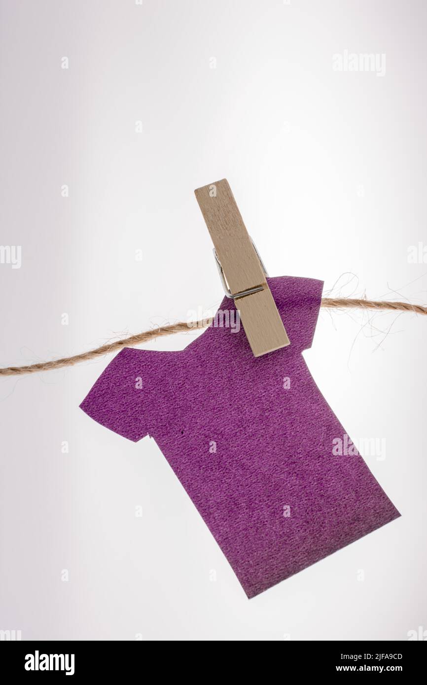Paper clothes hang on a rope with the help of clothespins Stock Photo ...