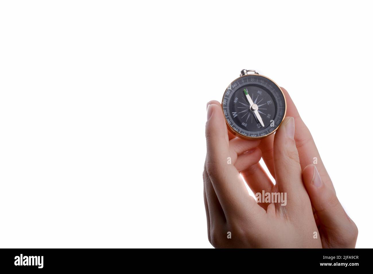 Isolated compass in child's hand on a white background Stock Photo - Alamy