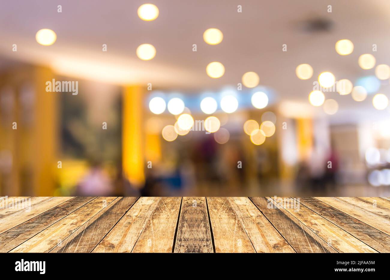 Old wooden table with blurred hotel lobby background for any design ...
