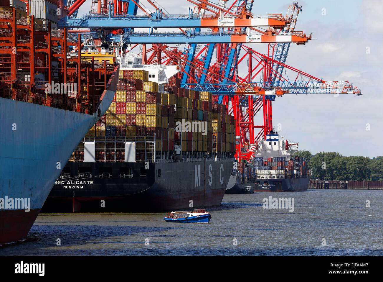 Small boat for harbour tours between container ships at the Eurogate ...