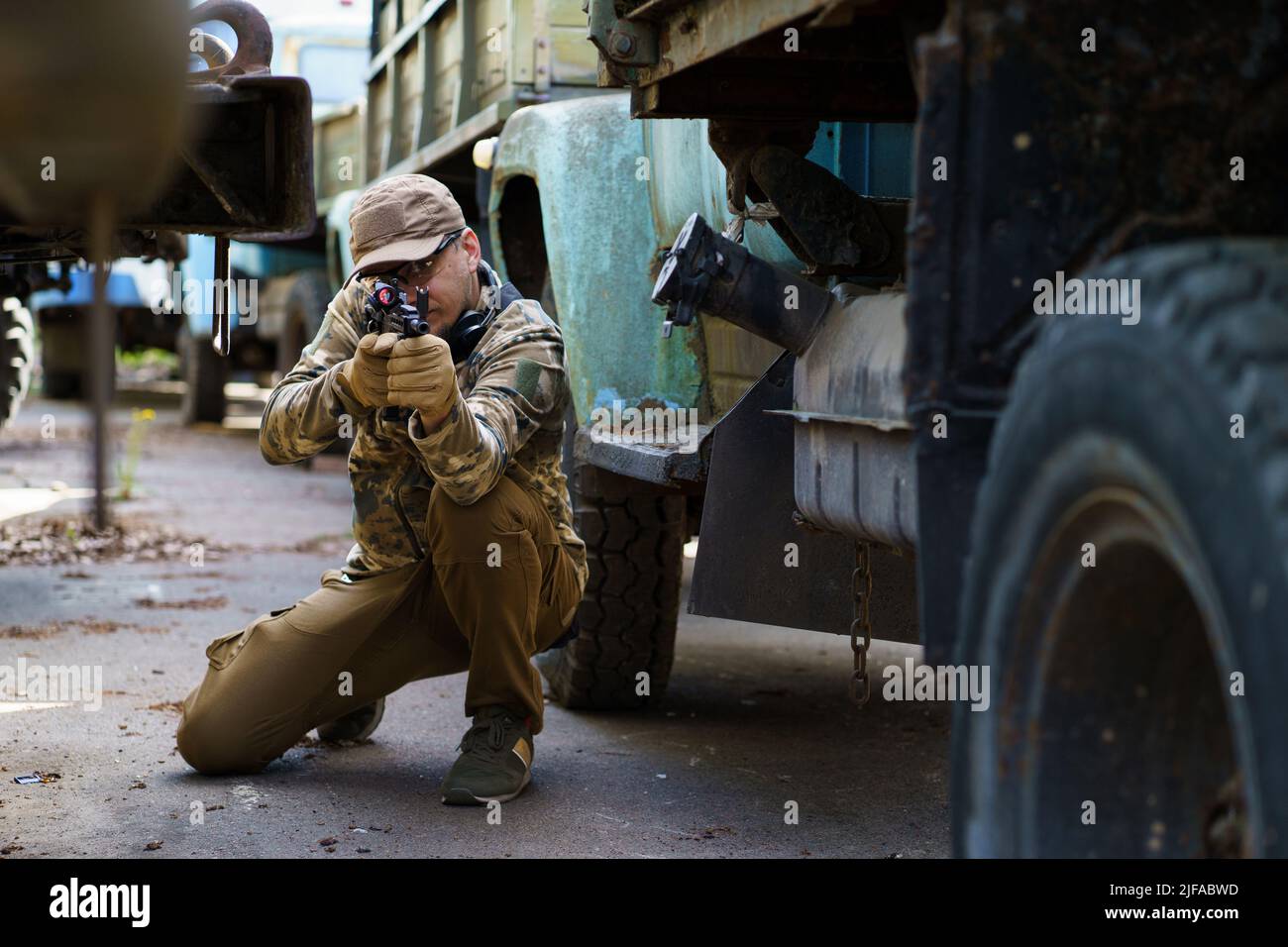 Young man in tactical training course. Outdoor shooting range. Private ...