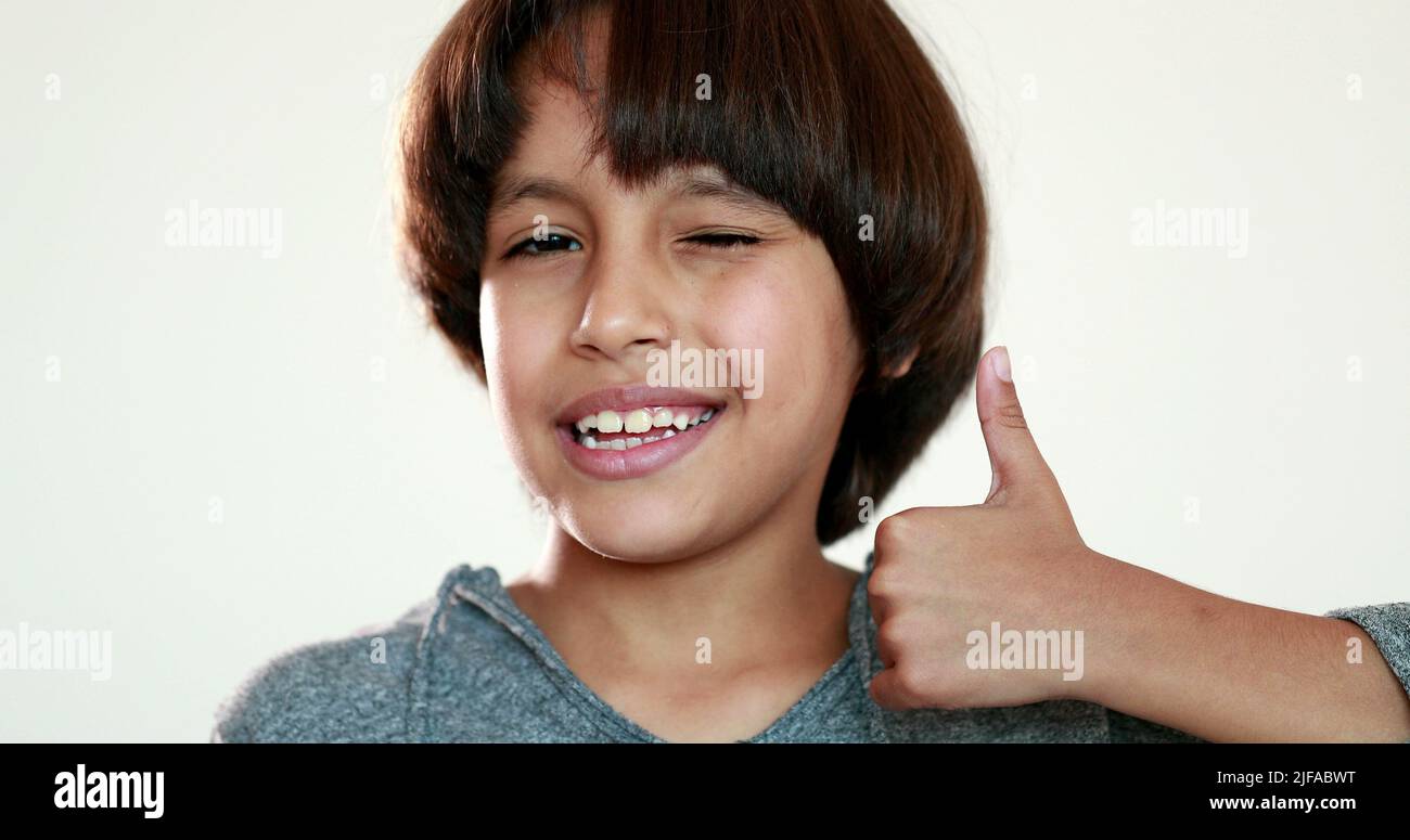 Child giving positive gesture with hand, kid thumb up Stock Photo - Alamy