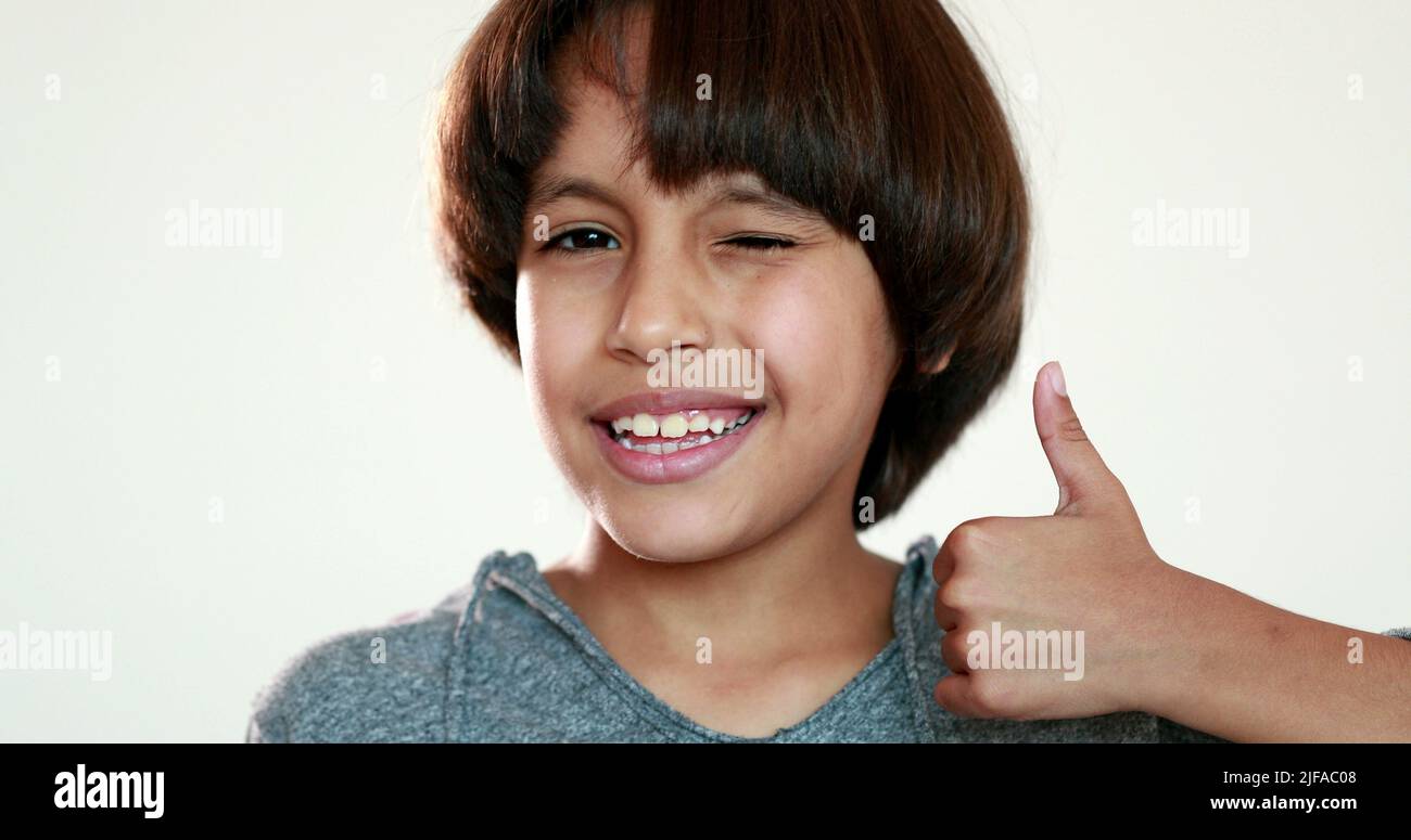 Child giving positive gesture with hand, kid thumb up Stock Photo - Alamy