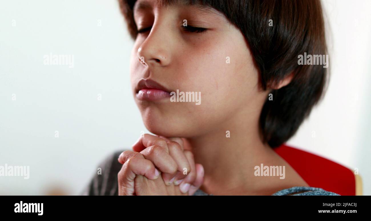 Child praying to God, spiritual child with hands held together, faitful ...