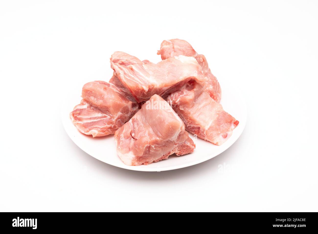 Raw Pork Bone Spine in white dish isolated on white background Stock ...