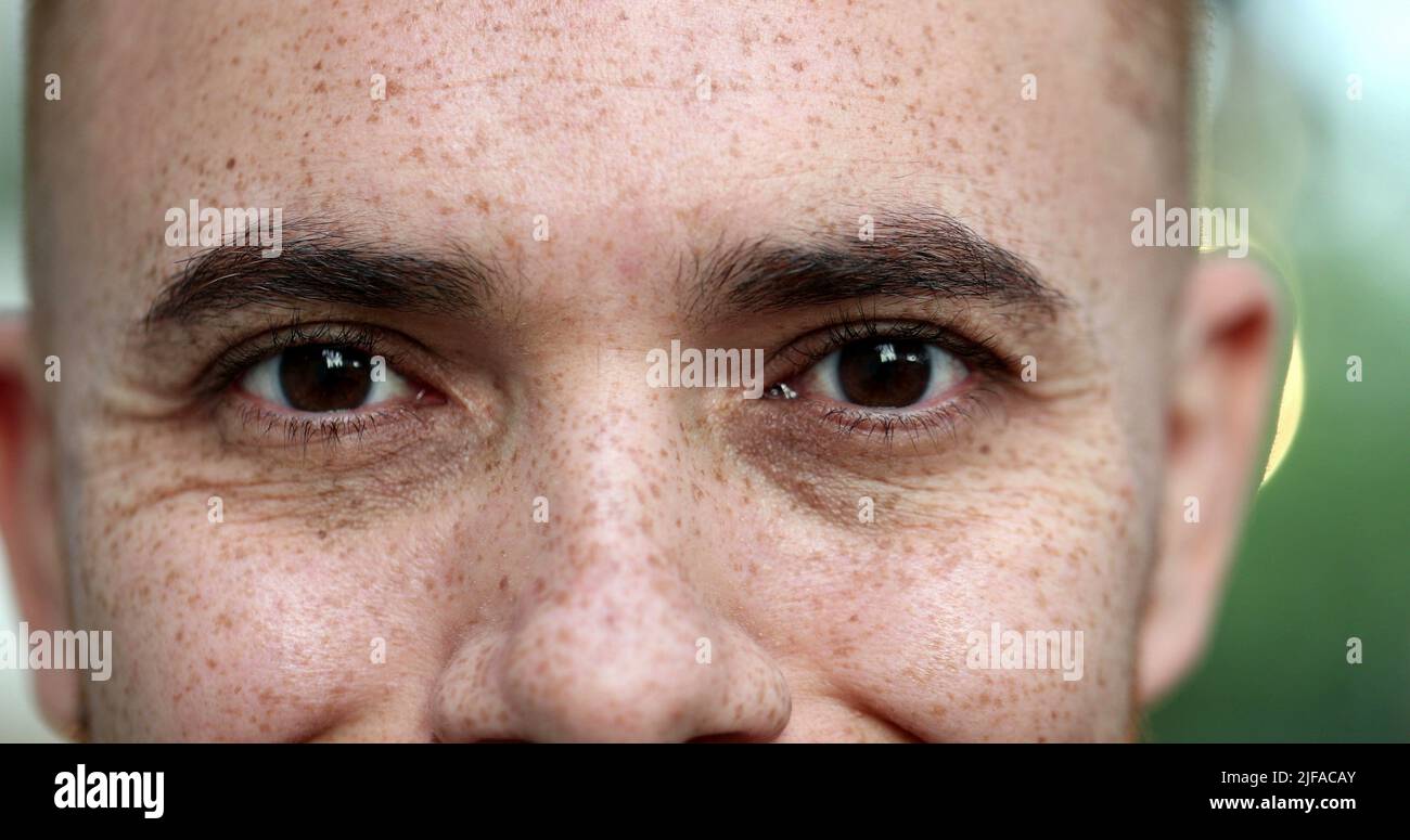 Contemplative young man closing eyes, taking a deep breath, feeling ...