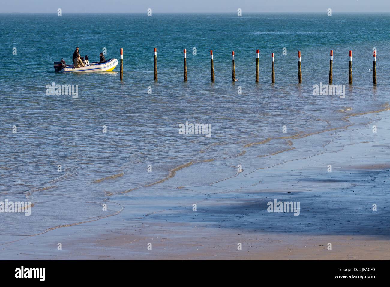 Red and white painted wooden bollard markers in the lagoon Stock Photo ...