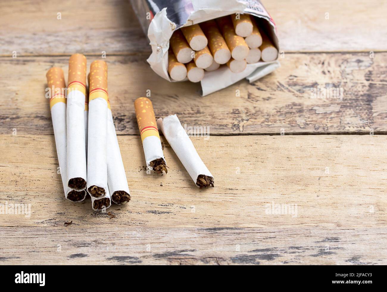 Tobacco cigarettes on a wooden table background Stock Photo - Alamy