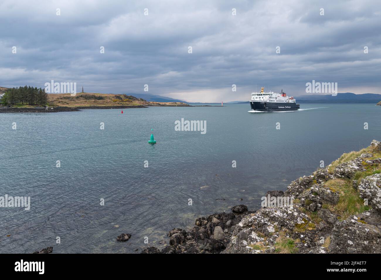 Ferry from the mainland near Oban coming into town from Mull, passing ...