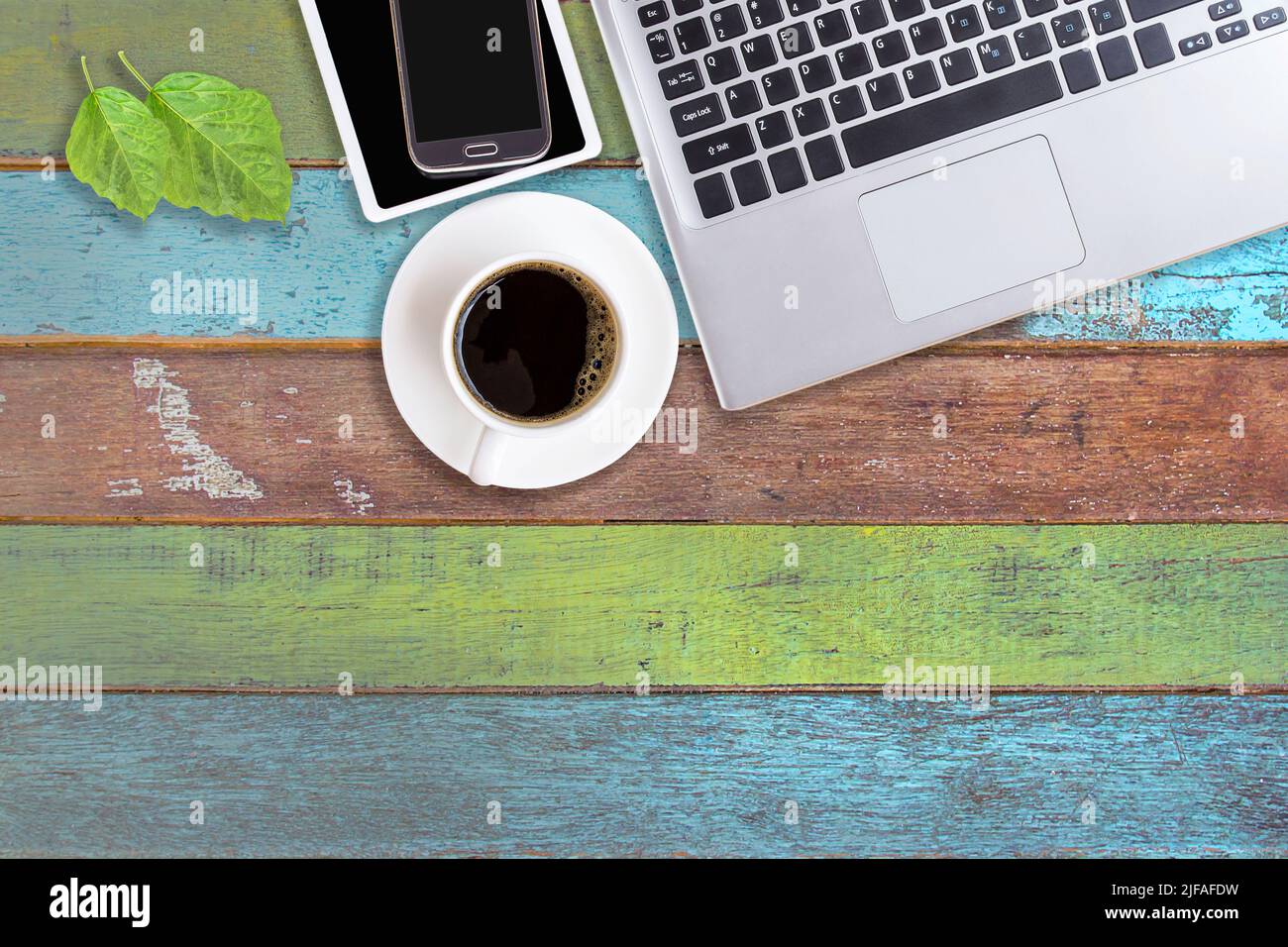 Office desk table with laptop computer, coffee cup and smart phone ...