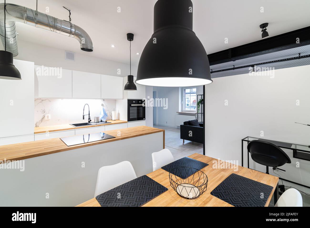 Modern kitchen with a dining area and a counter Stock Photo - Alamy