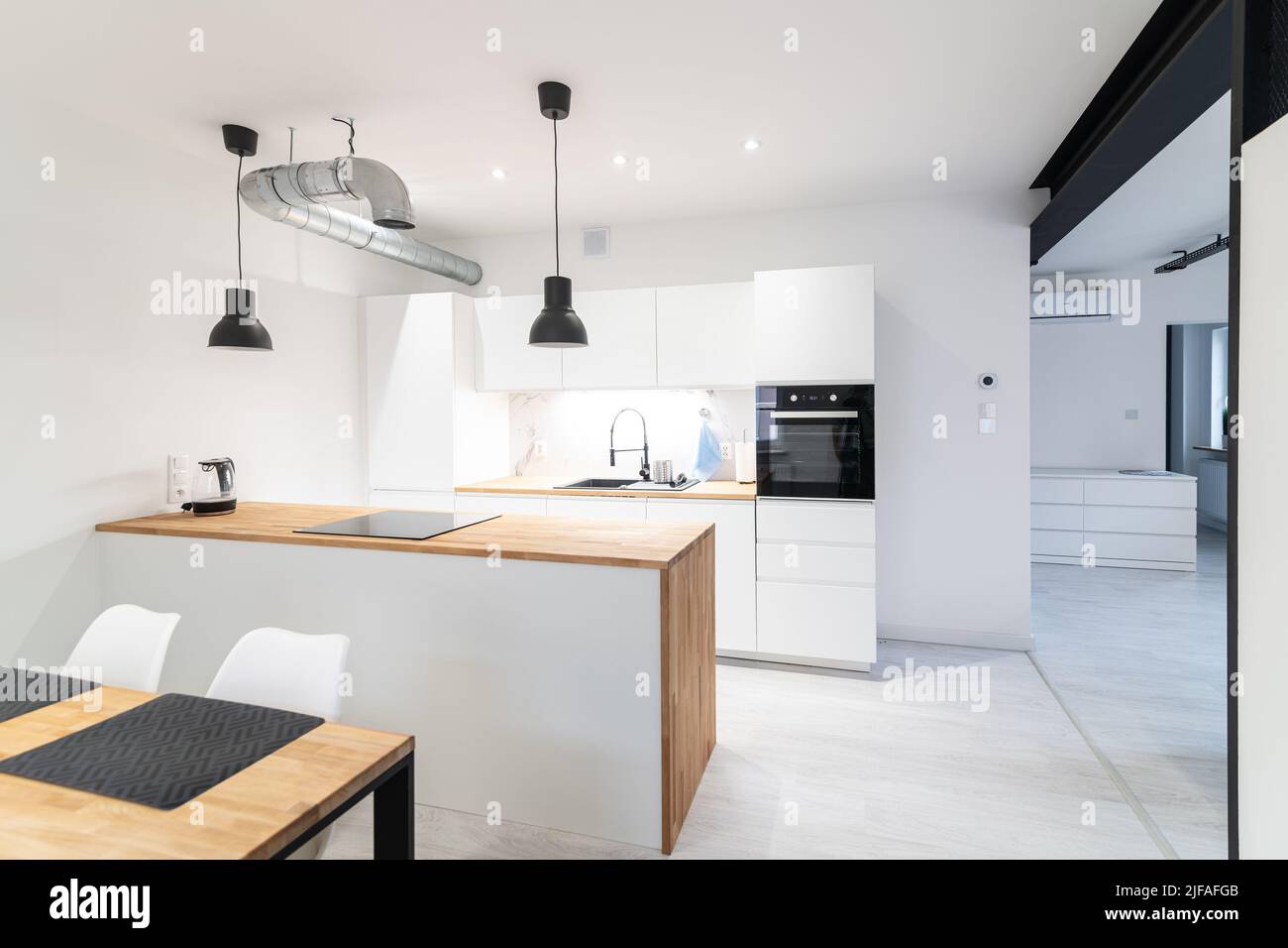Modern kitchen with a dining area and a counter Stock Photo - Alamy