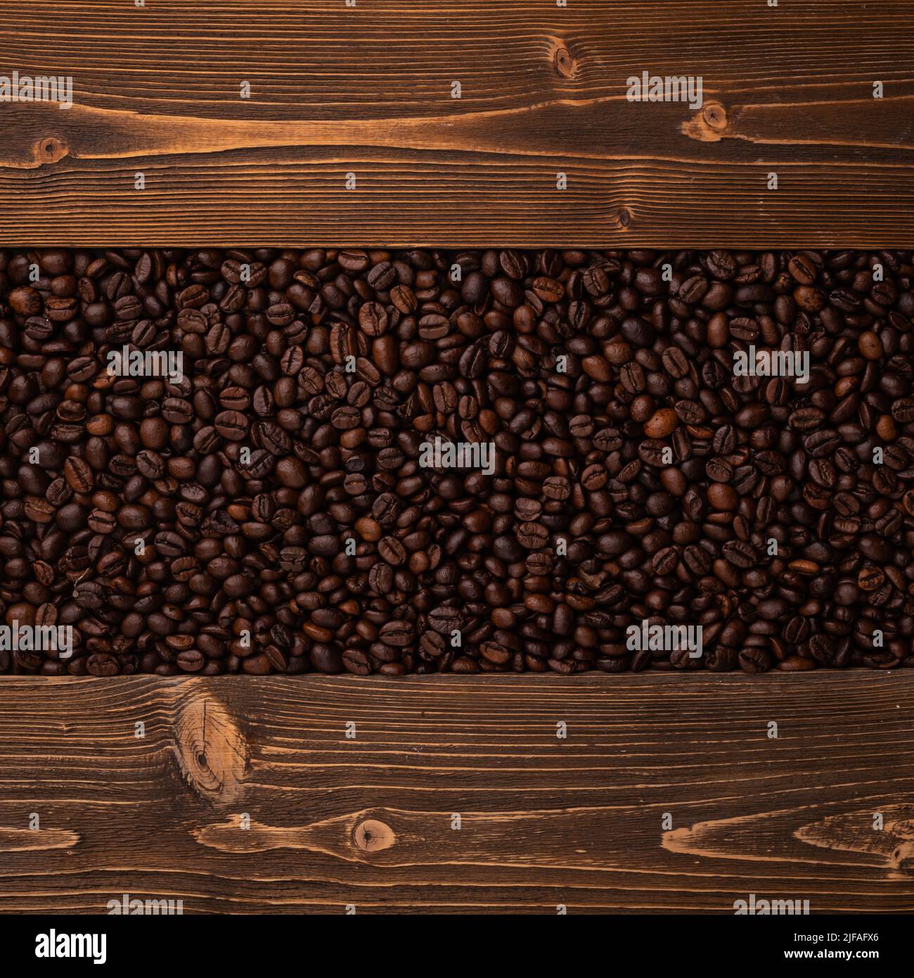 Half of Roasted coffee beans and wooden texture. Top view brown coffee ...