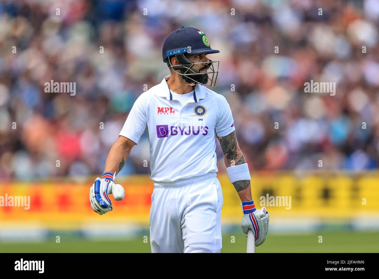 A dejected Virat Kohli of India leaves the field after being bowled out ...