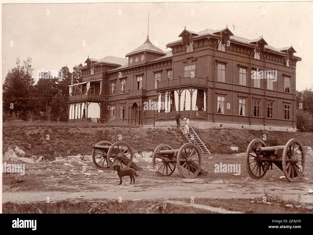 Large regiment building (fair?) On Rindö. People sit on the porch, at ...