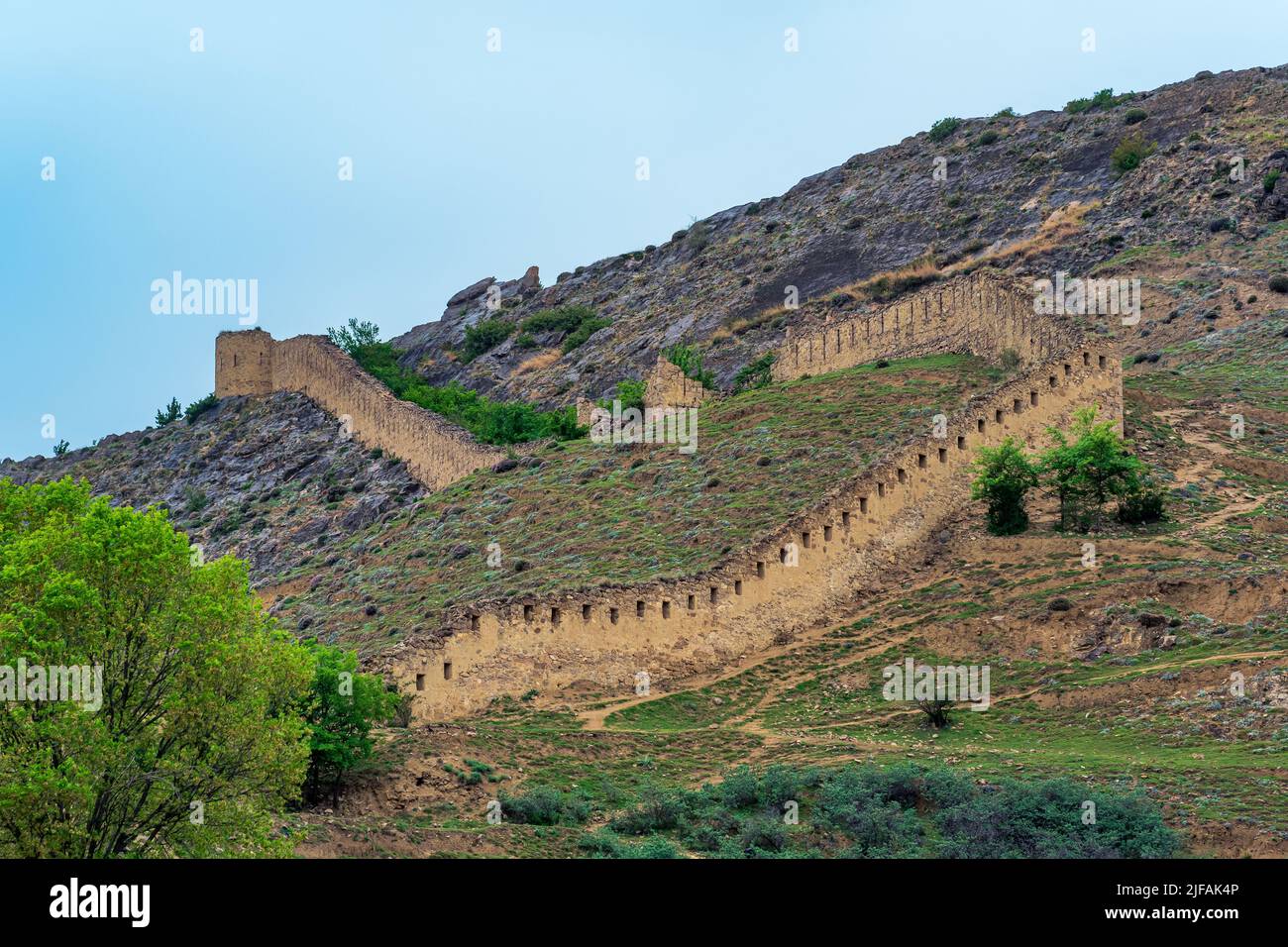 medieval fortress wall on a mountain slope, Shamil (Gunib) fortress in ...