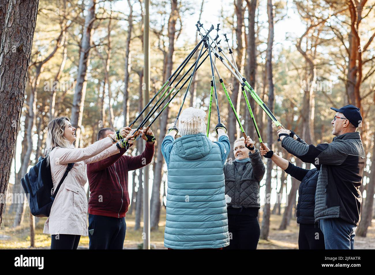 Group people different ages making Nordic walking with trekking sticks ...