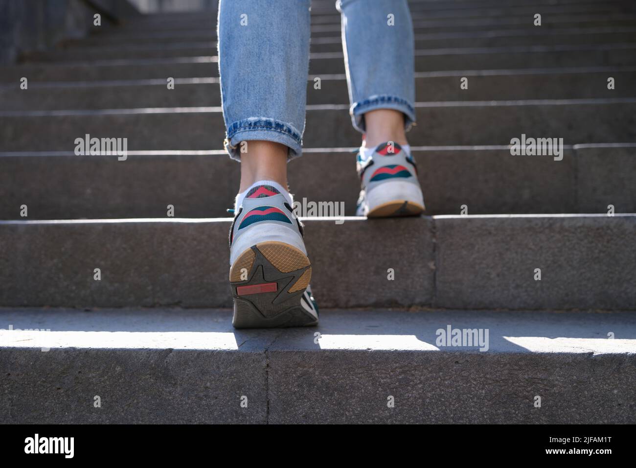 Woman climbs stairs to street closeup. Daily walks and healthy ...
