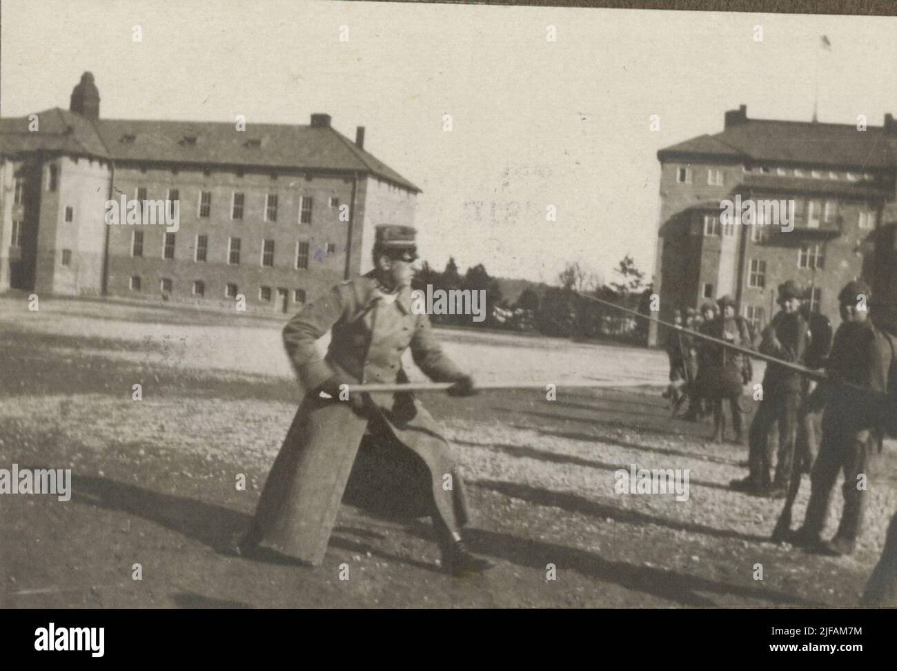 A soldier is fencing with a shovel. Soldiers in a row stand and observe ...