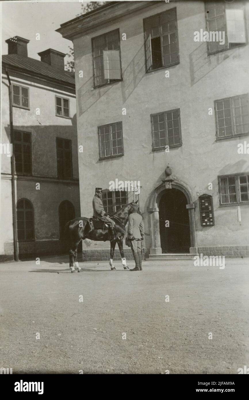 An officer on a horse meets a soldier outside the Military University ...