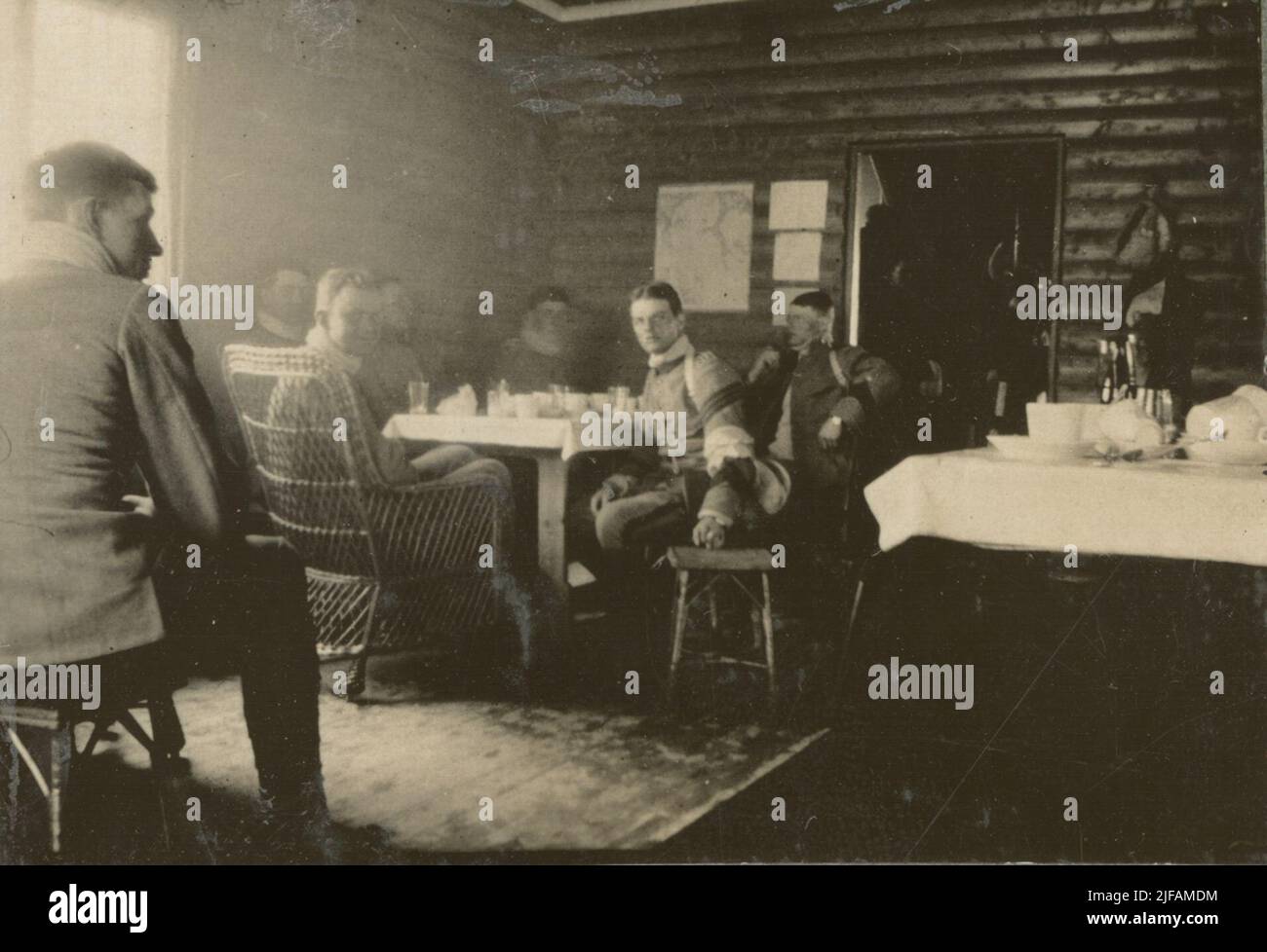 Interior image with soldiers gathered around dining tables. The table ...