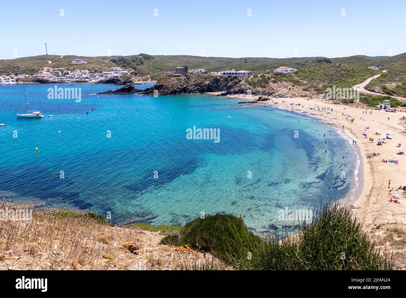 Menorca, Spain - Jun 30, 2022: People bathing in the transparent waters ...