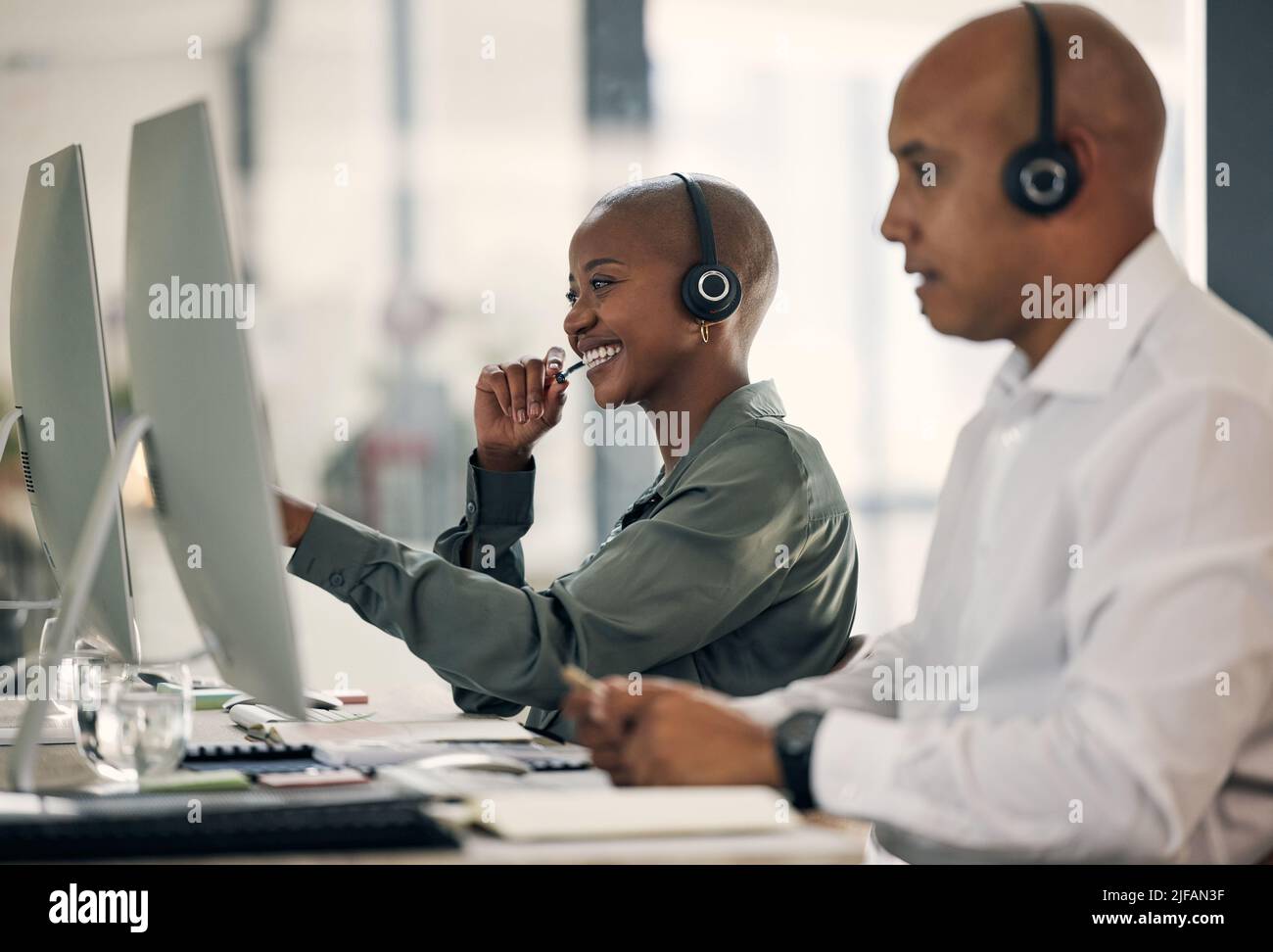 Happy young african american call centre telemarketing agent talking on ...