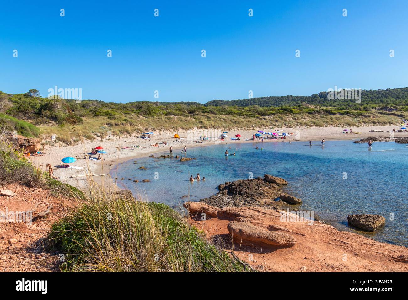 Menorca, Spain - Jun 30, 2022: People bathing in the transparent waters ...