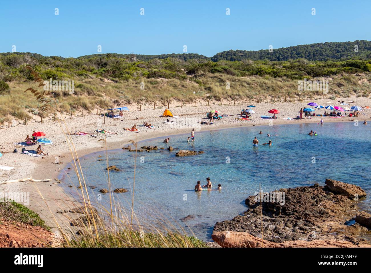 Menorca, Spain - Jun 30, 2022: People bathing in the transparent waters ...