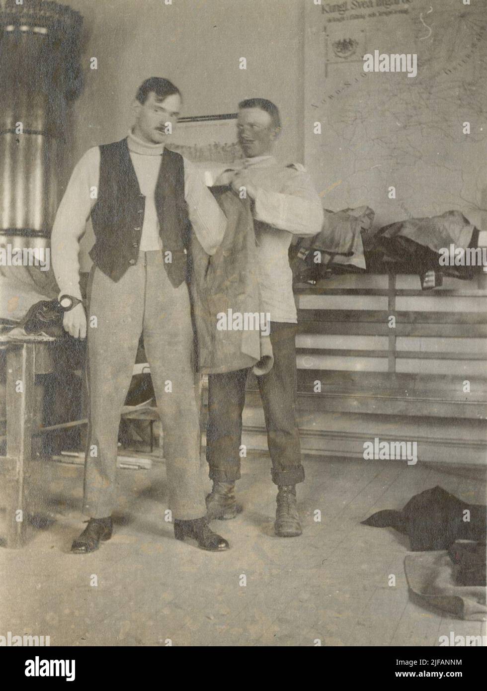 A soldier gets help to dress the uniform rock Stock Photo - Alamy