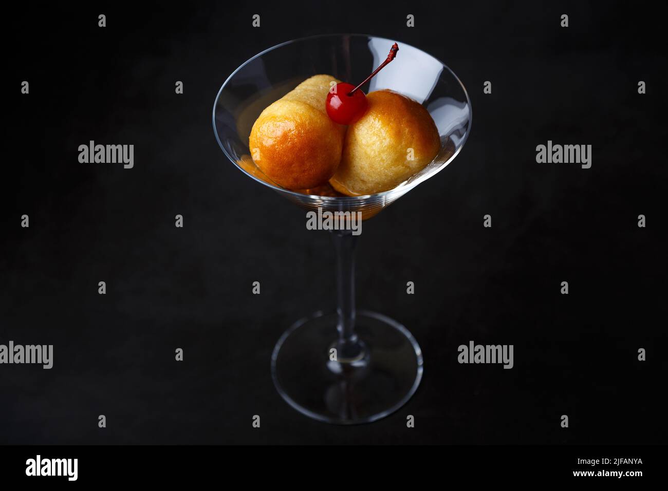 Neapolitan Rum baba (or baba au rum) in a martini glass with a cocktail ...