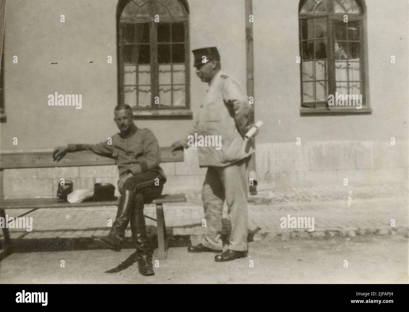 Two soldiers at a bench in front of a building Stock Photo - Alamy