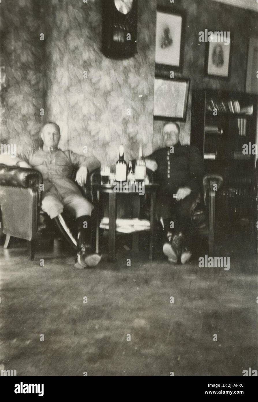 Two men in uniform sitting in armchairs Stock Photo - Alamy