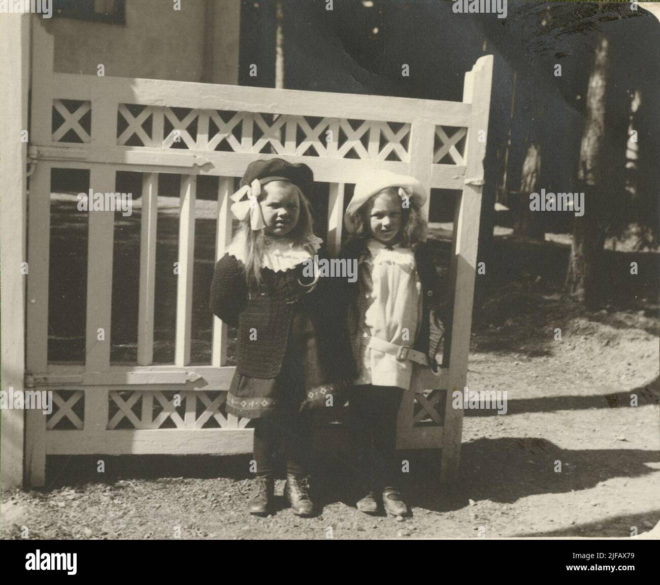 Portrait of two girls at the gate Stock Photo - Alamy