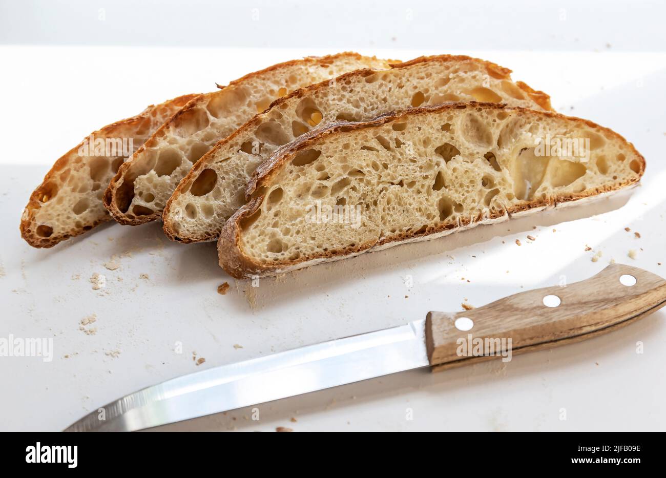White sliced bread and a knife. Four slices of sliced bread Stock Photo ...