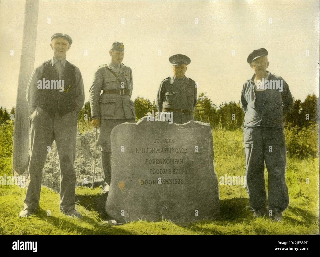 Group portrait of four men in memorial stone over soldier from Hälsinge ...