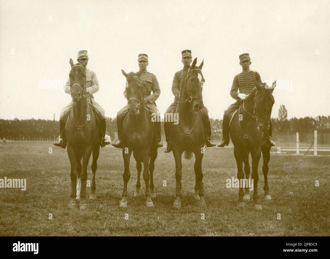 Olympic group of 4 riders on horseback set up on the obstacle course at ...