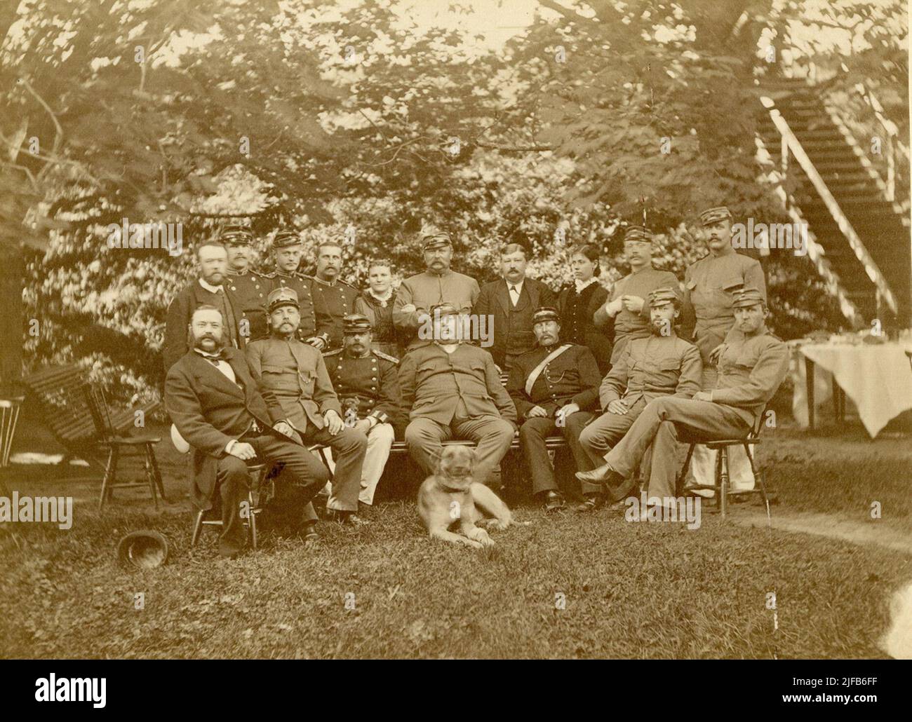 Officers, soldiers and civilian -clad people in the garden outside the ...