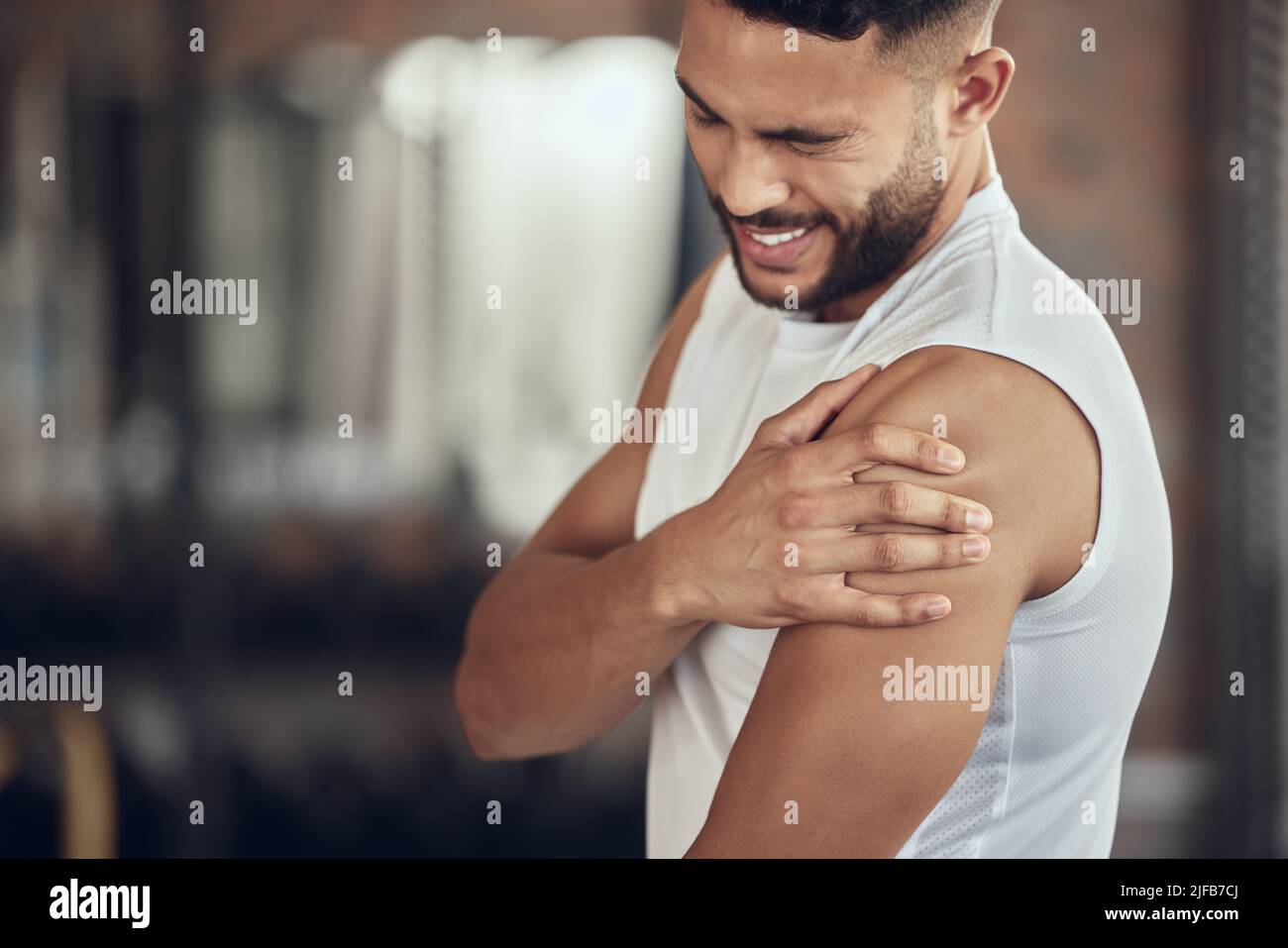 Young athlete experiencing arm pain. Bodybuilder with a bicep cramp in ...