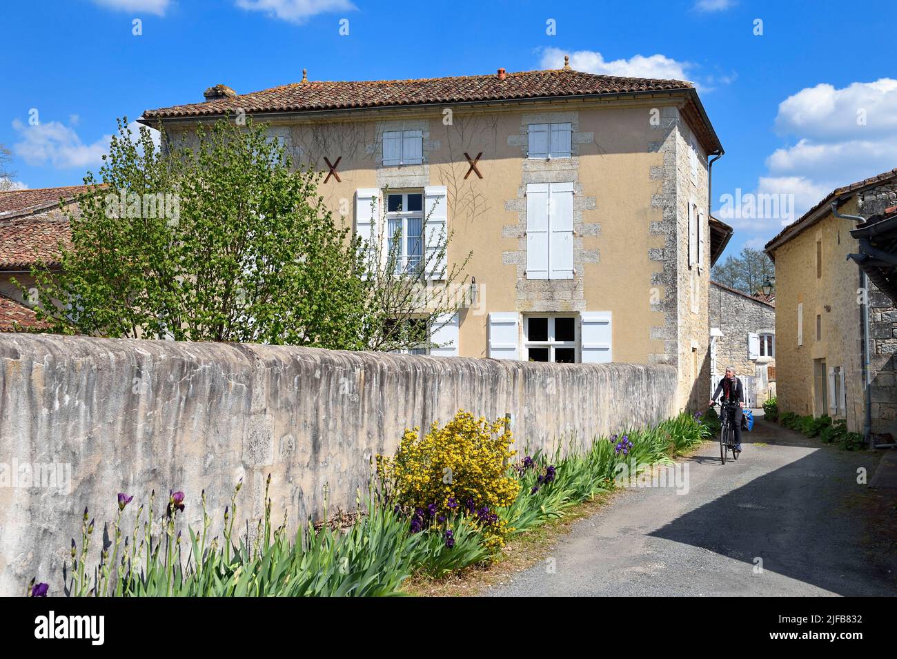 France, Charente, cyclist discovering the village of Feuillade on the ...